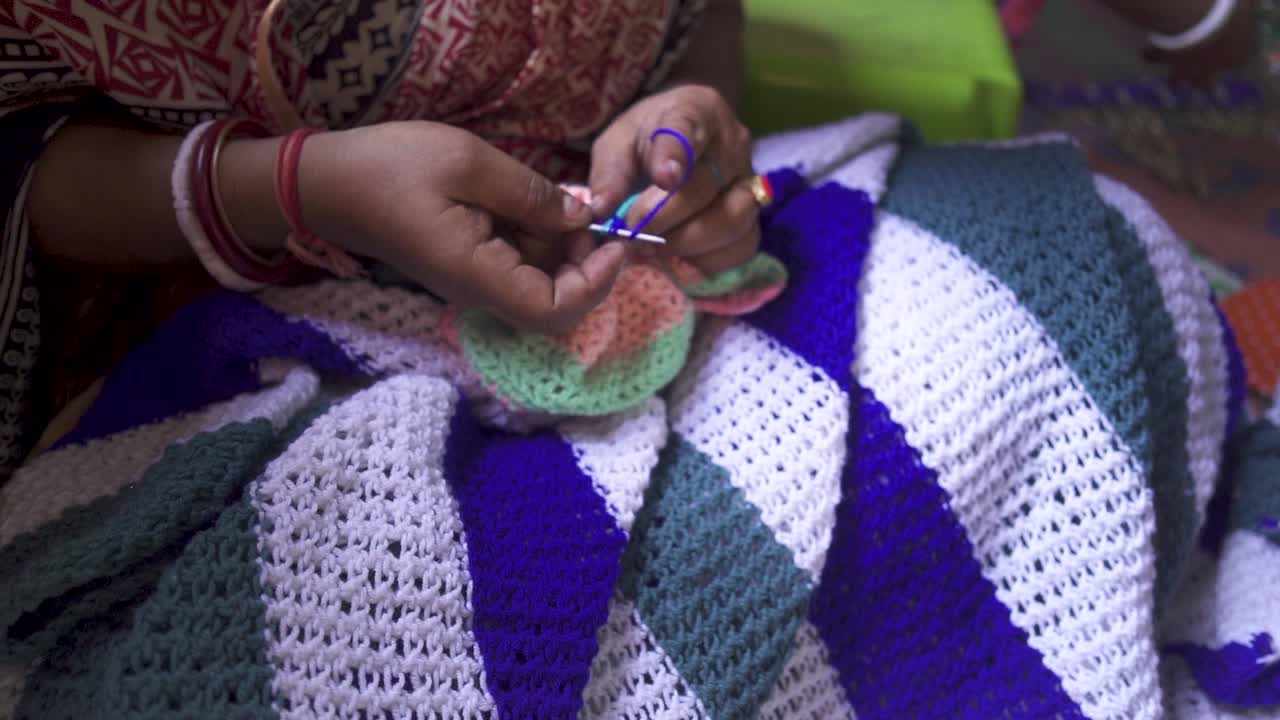 Premium stock video - Unrecognized indian woman knitting woolen sweater