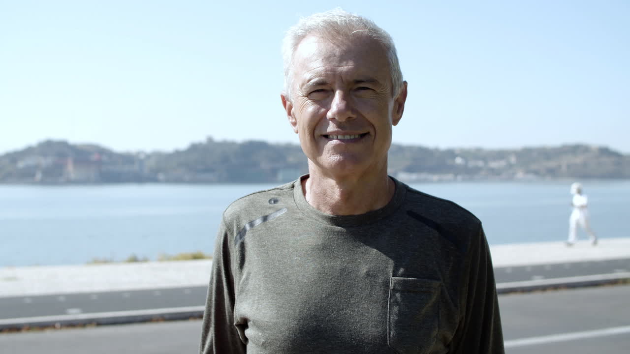 Positive active elder 60s man in sportswear standing outdoors | Free ...