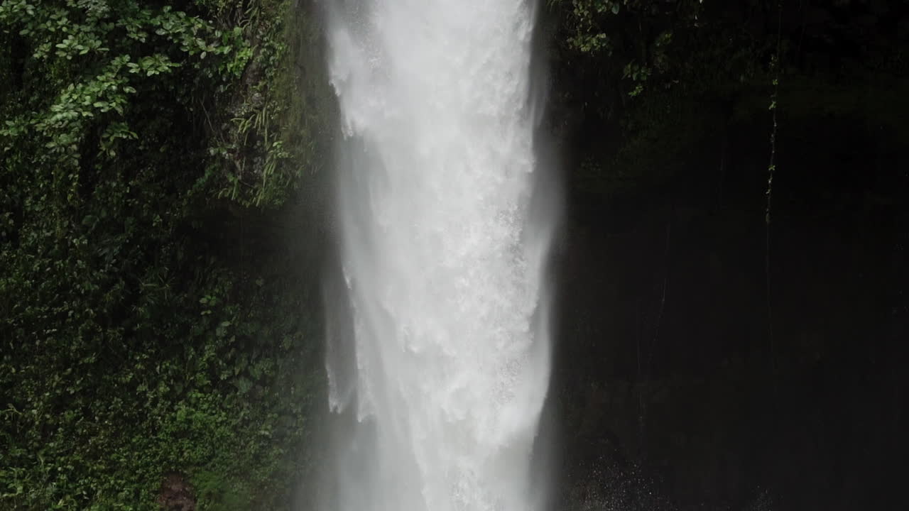 Premium stock video - Slow motion shot following water down rain forest ...