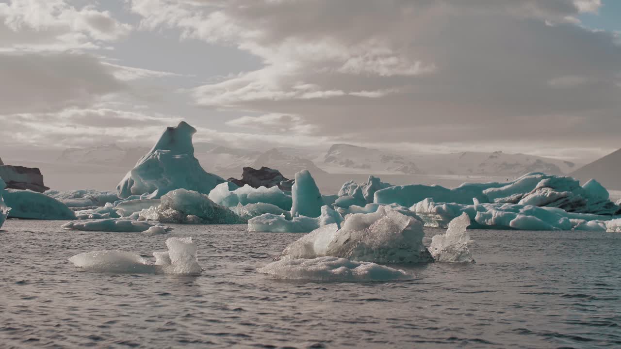 Premium stock video - Static shot of big blocks of blue ice floating on ...