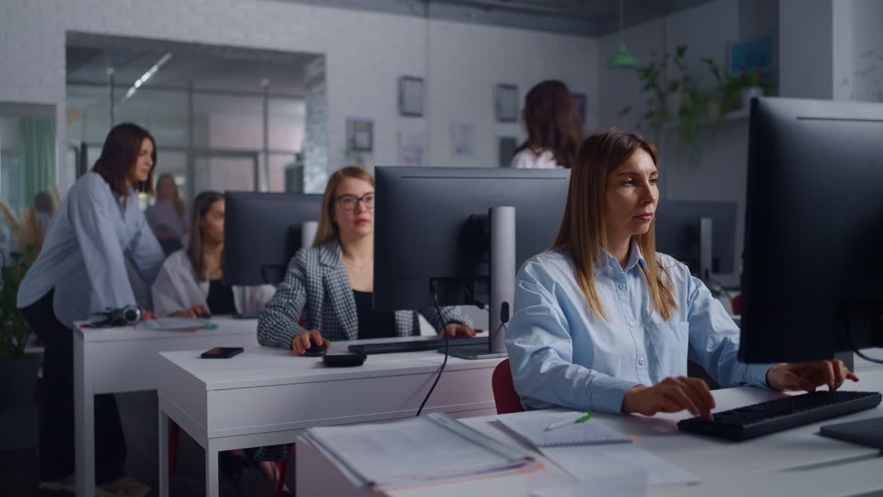 Women working at computers in an office | Premium Stock Video Footage