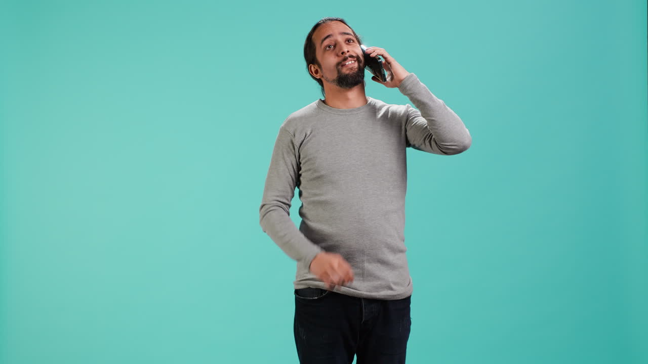 Premium stock video - Joyous man catching up with friends in phone call ...