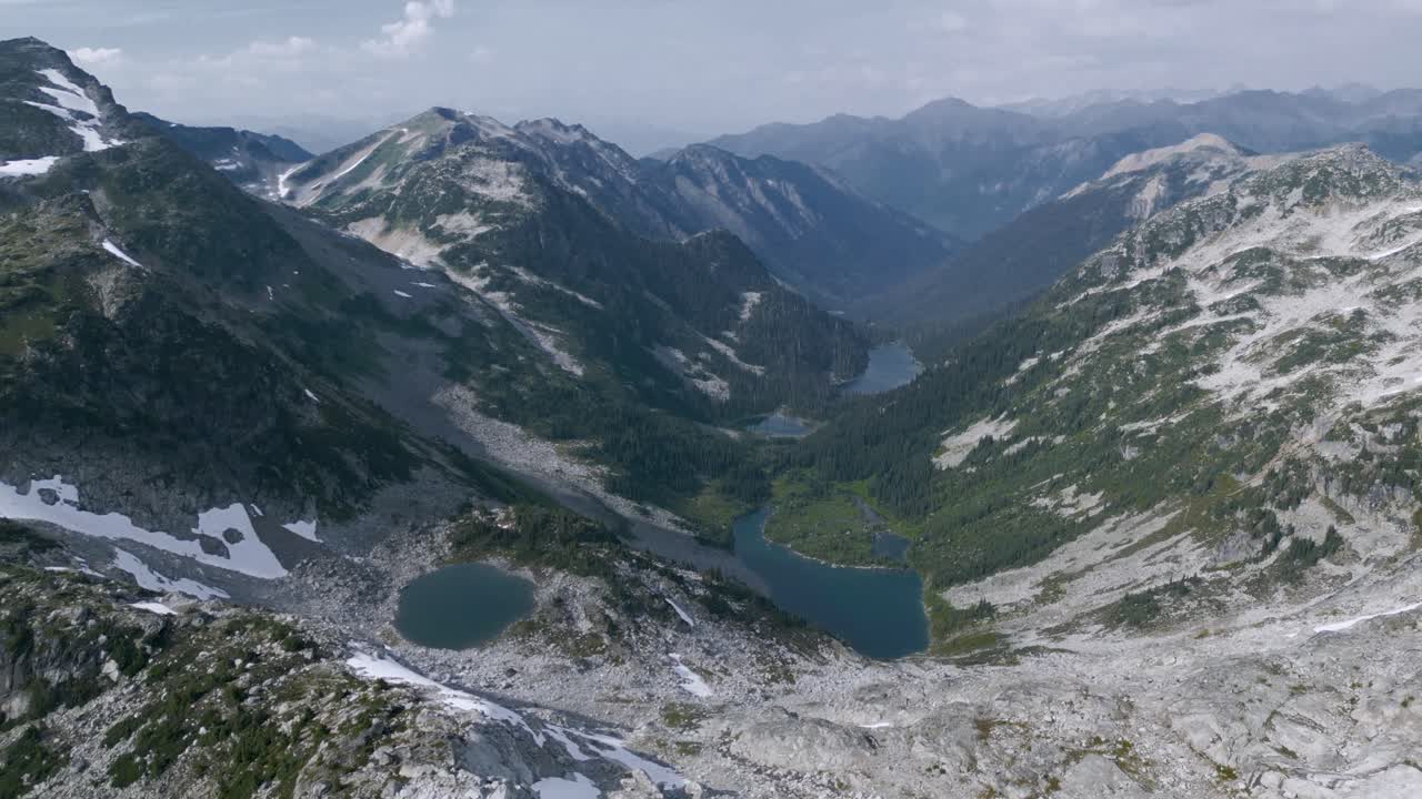 Flying Over The Mountain Ridge Revealing Multiple Turquoise Lakes ...