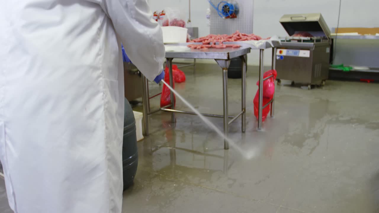 Female butcher cleaning the floor | Premium Stock Video Footage
