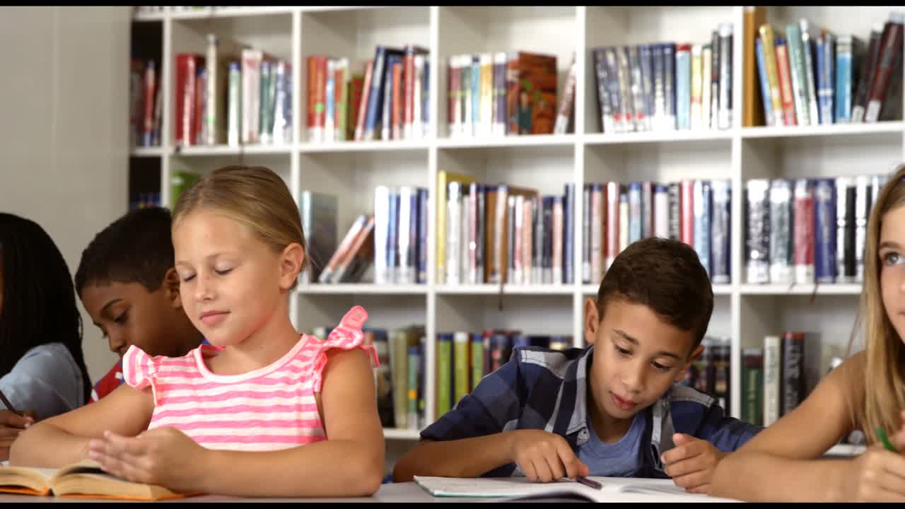 Premium stock video - School kids studying in library
