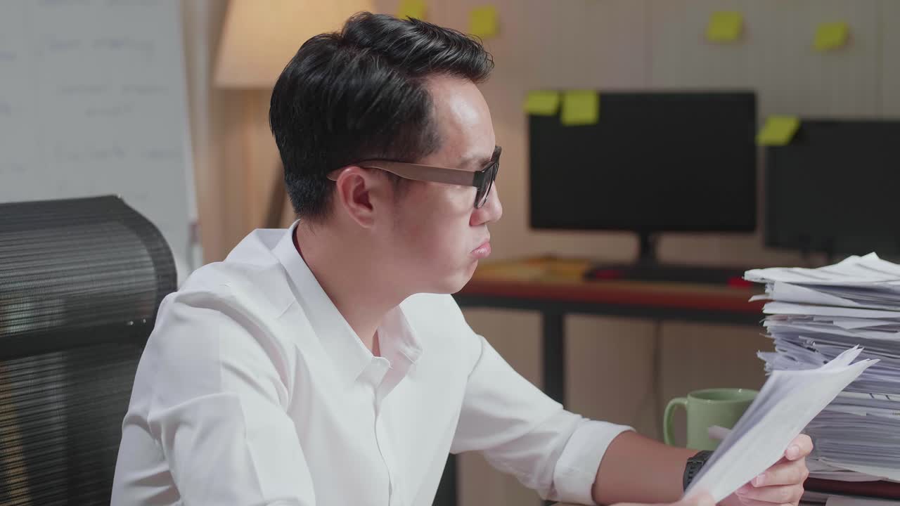 Close Up Of Asian Man Being Tired Working Hard With Documents | Premium ...
