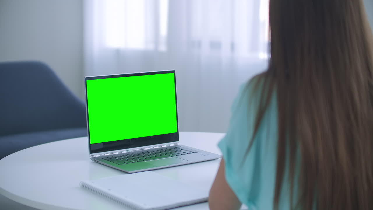 Girl Taking Notes In Notepad From Laptop Computer Green Mockup Screen ...