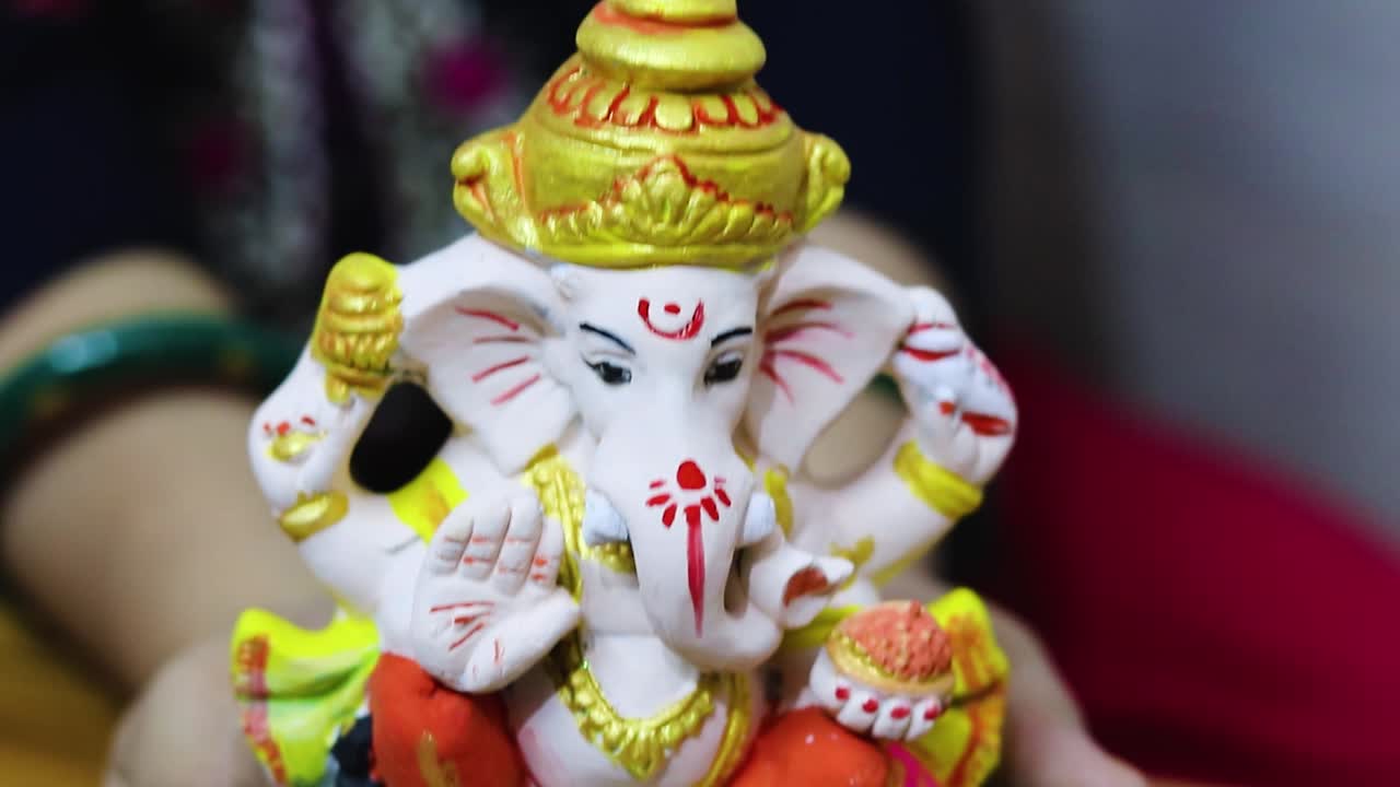 Premium stock video - Devotee holding the hindu holy god ganesha idol ...