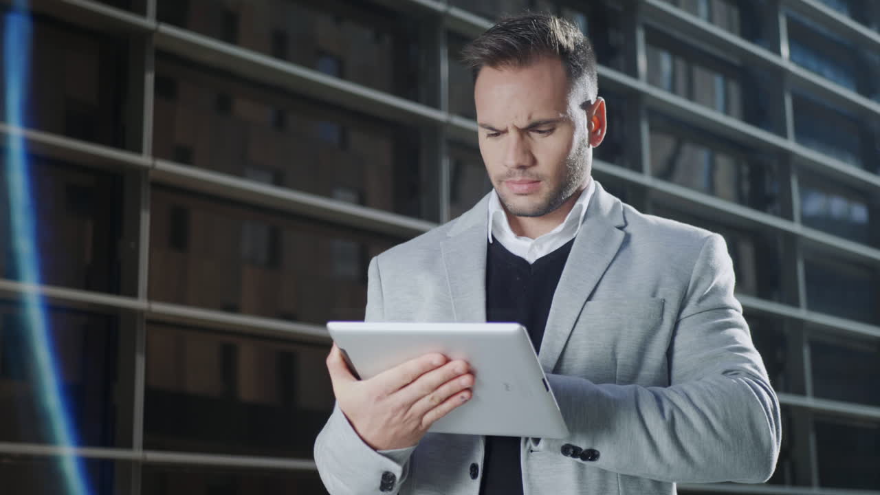 Premium stock video - Businessman working on digital tablet in city ...