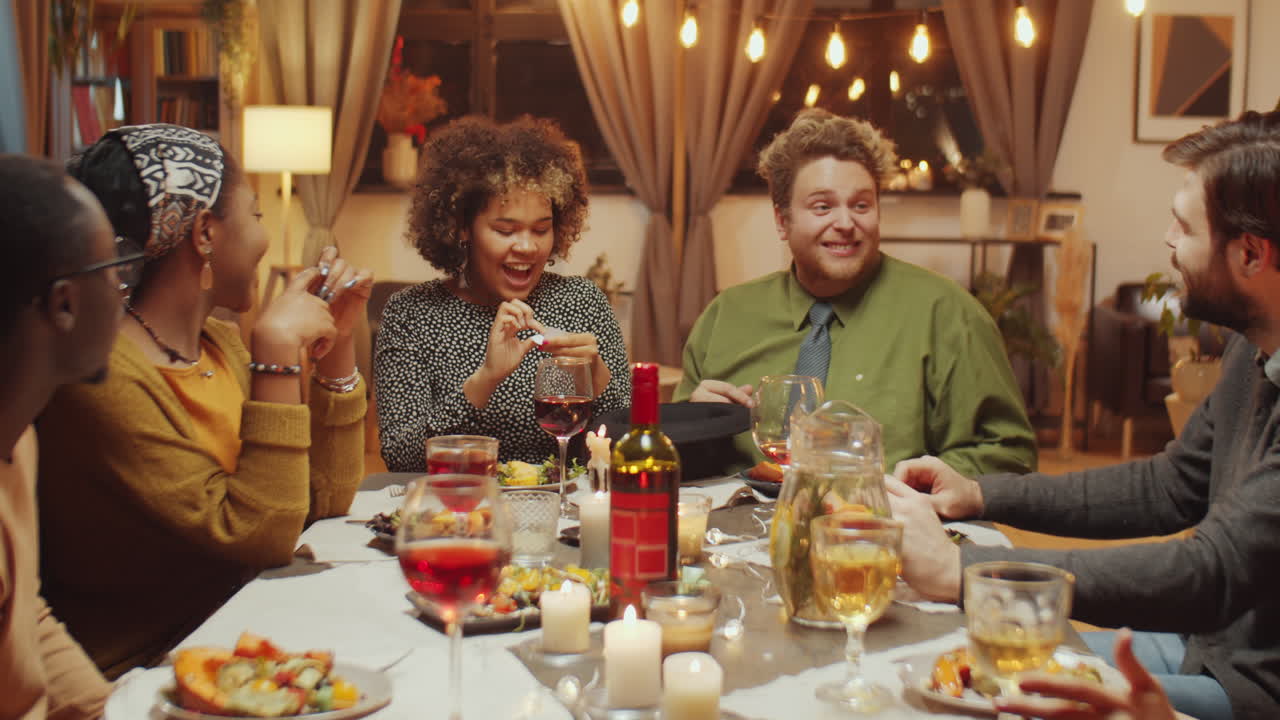 Premium stock video - Friends playing game during party