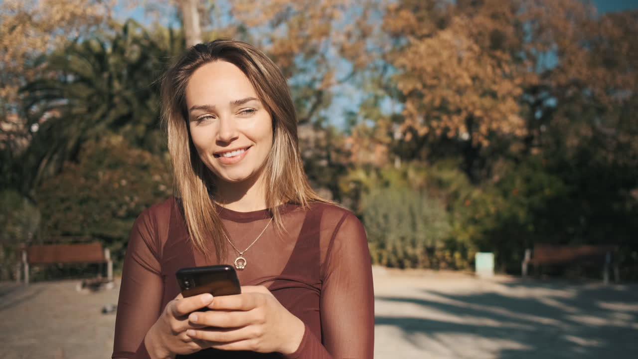 Free stock video - Shy woman texting message and biting her lips.