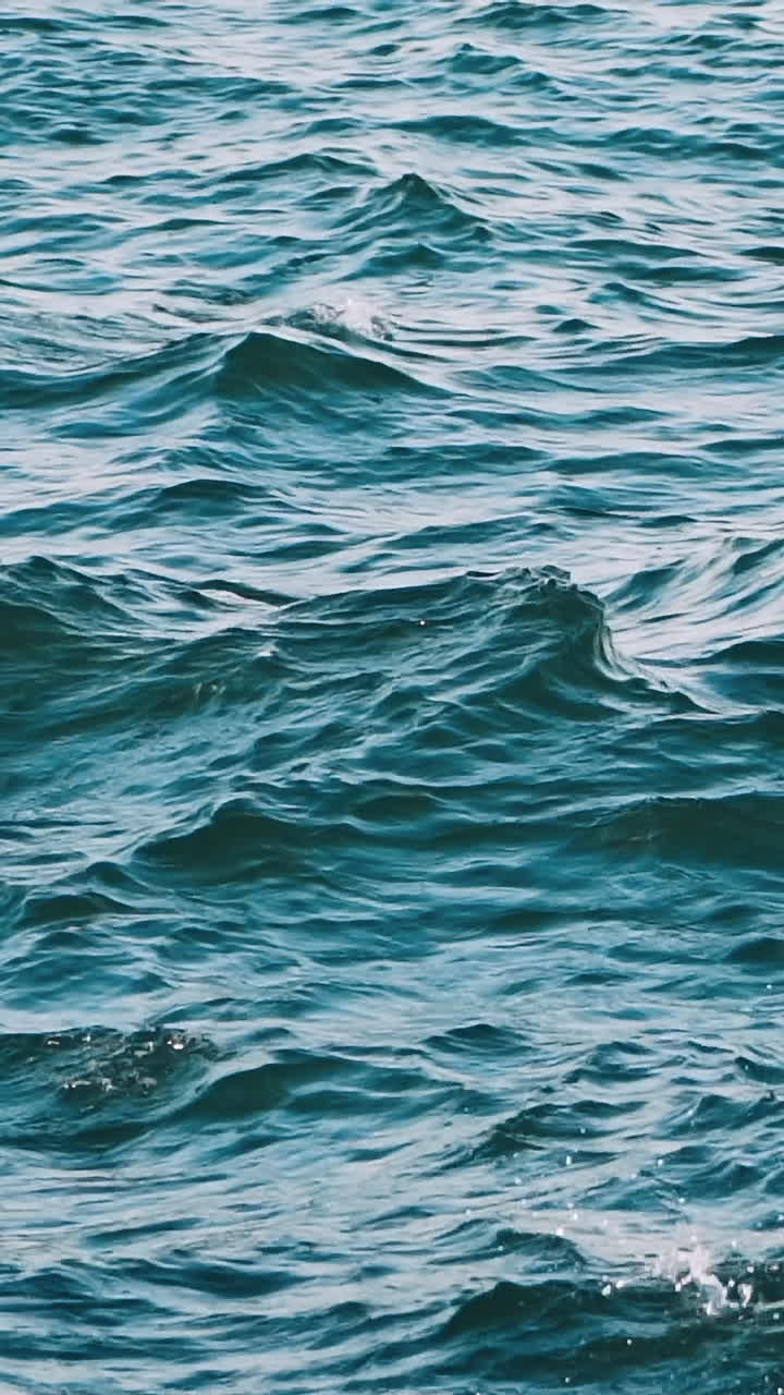 Flowing water surface. Close up of disturbed blue ocean water surface ...