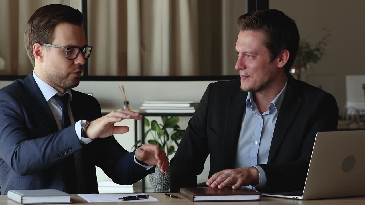 Two male partners talking communicating in office. | Premium Stock ...
