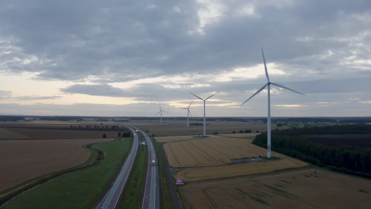 Premium stock video - Wind turbine next to road during a cloudy day in ...