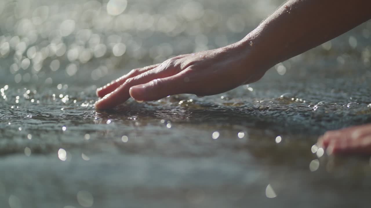 Premium stock video - Hand moving slowly in water