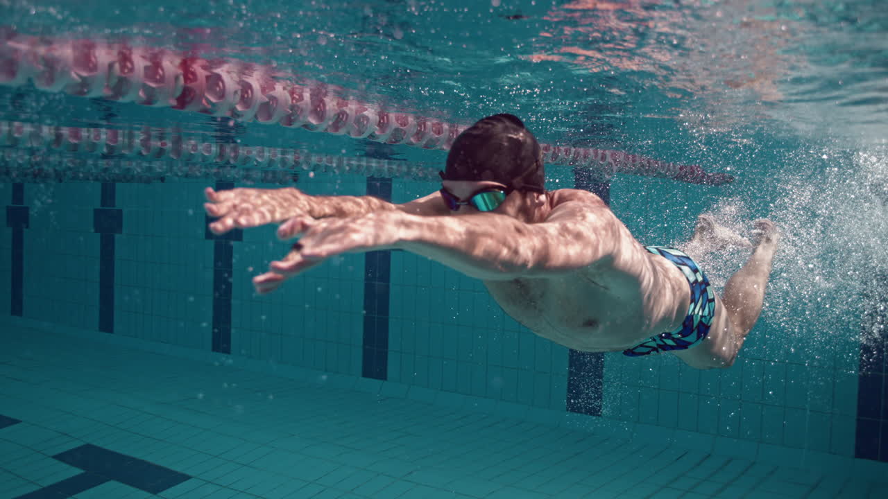 Slow Motion Professional Swimmer Underwater Pushing Wall And Swimming ...