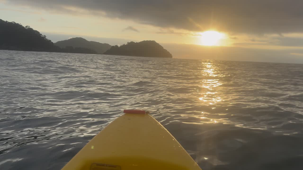 Premium stock video - A drifting kayak at sunset