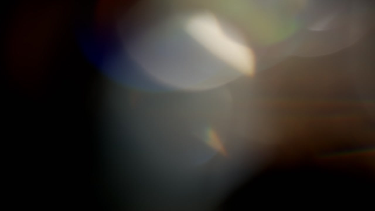 Premium stock video - Multicolored light leaks 4k footage on black ...