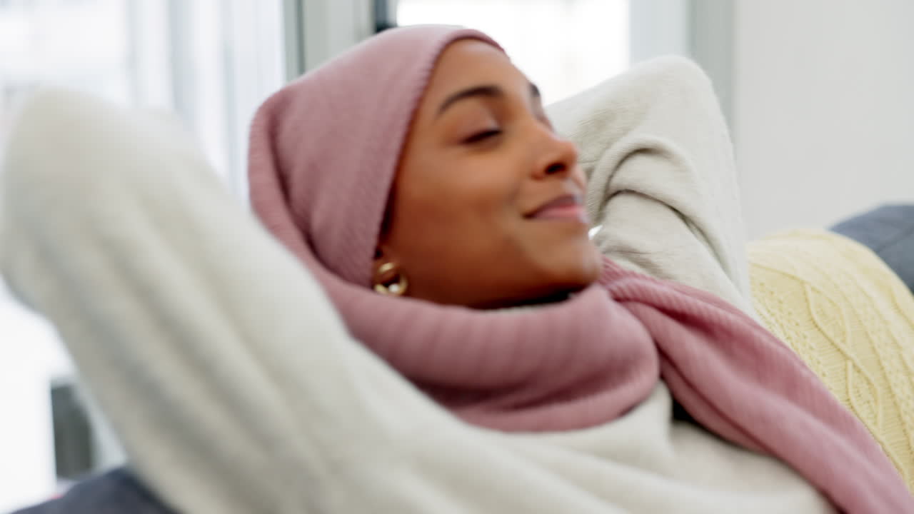 Premium stock video - Happy, relax and sleeping muslim woman on the sofa