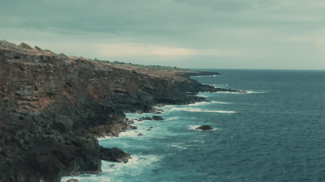 4k aerial high volcanic cliff on calm ocean drone dolly in shot Premium ...