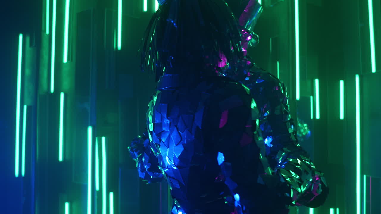 A silver pair of people in love dance together and rotate in neon light ...