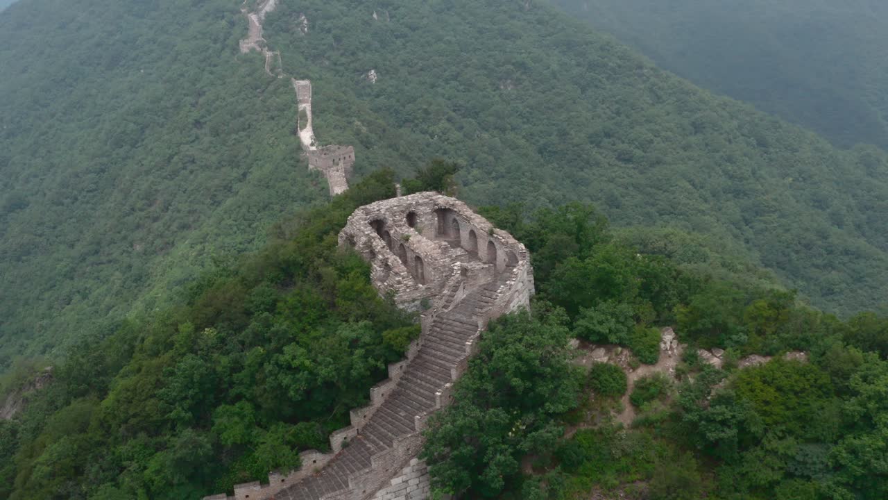 Aerial push in on deteriorated lookout tower of rural part of Great ...