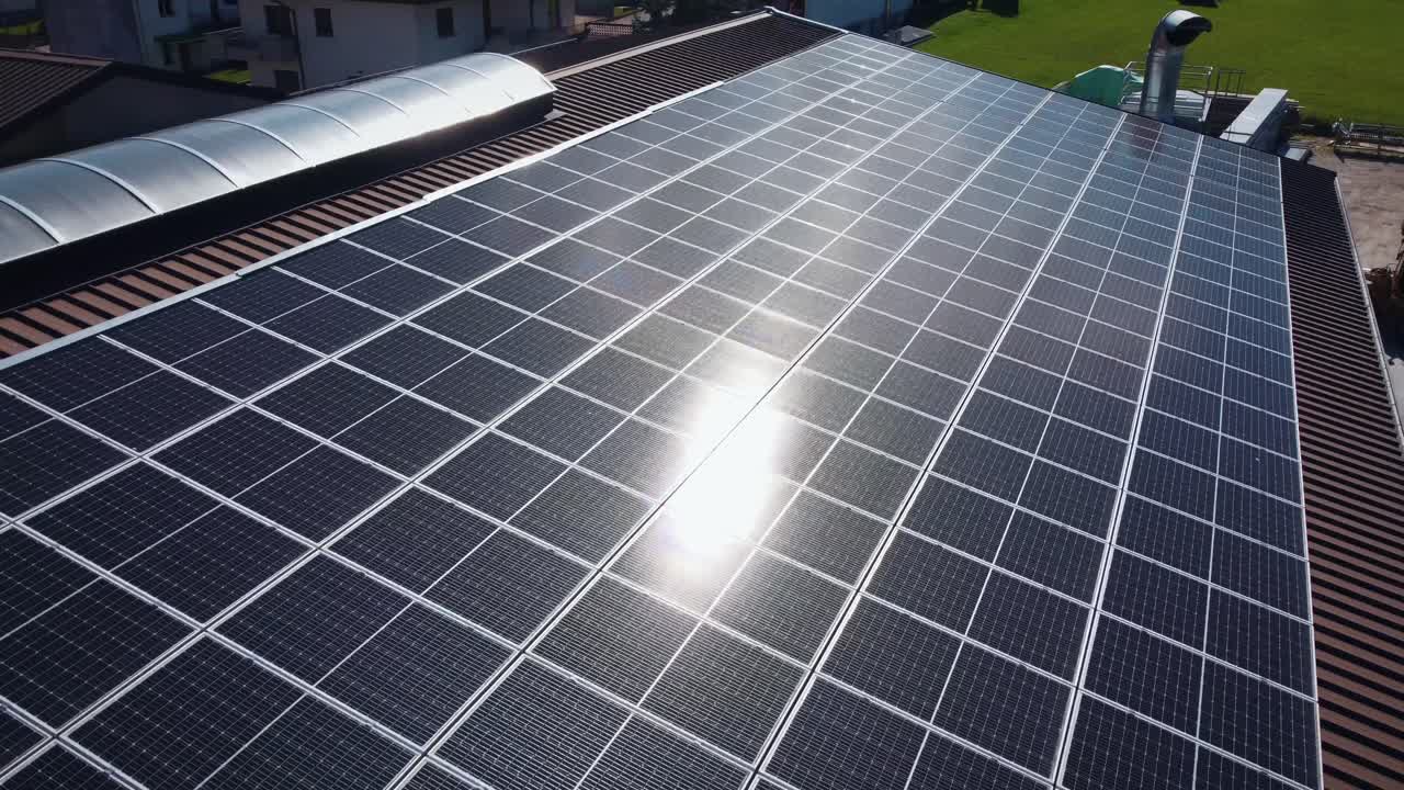 Premium stock video - Sun reflection of solar panels on top of house ...