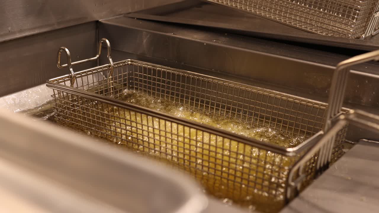Premium stock video - Deep frying food in hot bubbling oil