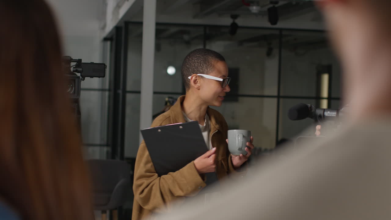 Free stock video - A film crew interviewing a woman on a film set