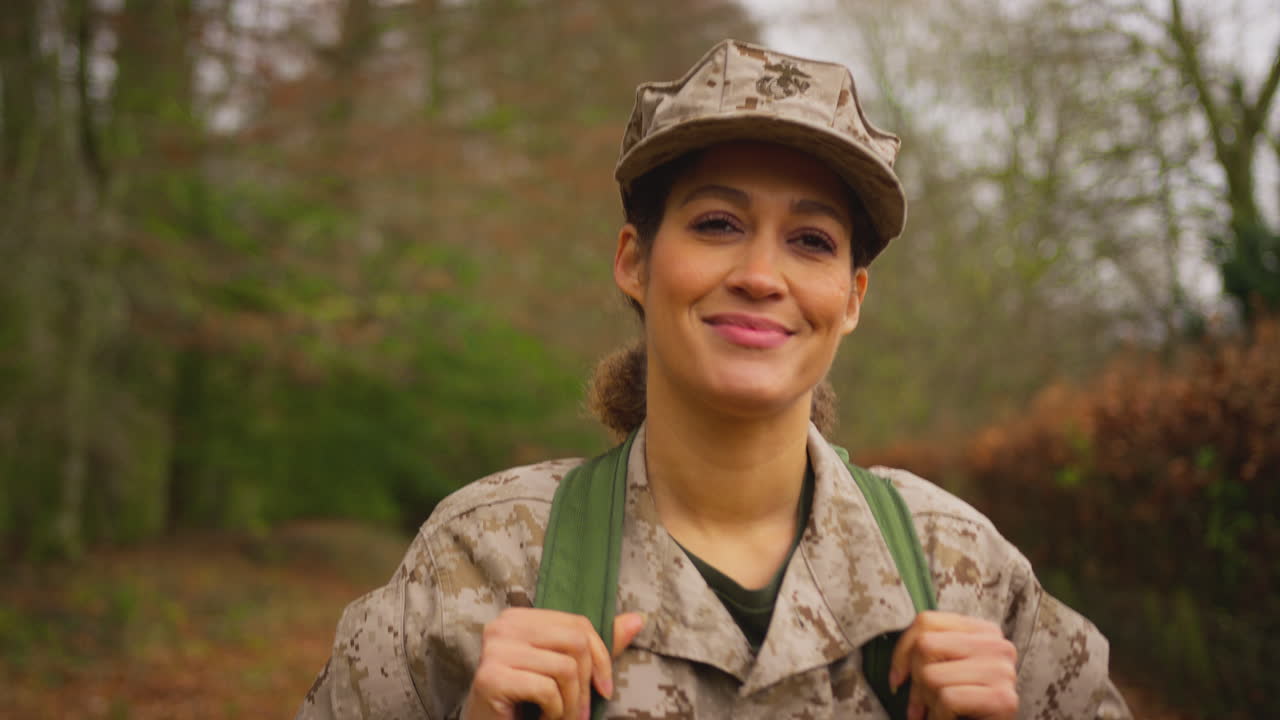Premium stock video - American female soldier in uniform carrying ...