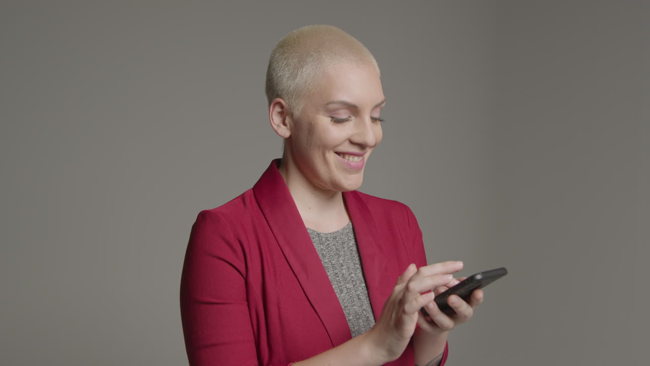 Free stock video - Female model posing with smartphone during studio ...