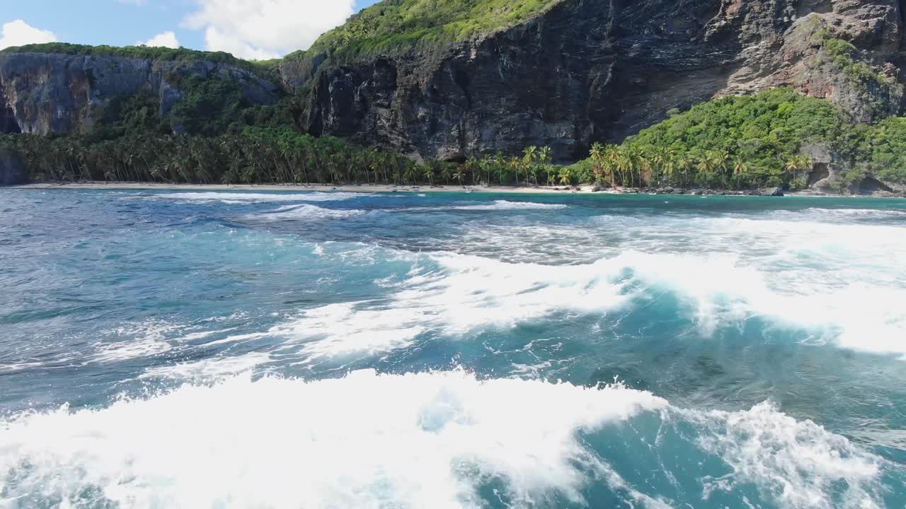 Aerial flyover wavy Caribbean Sea with Playa Fronton in background ...
