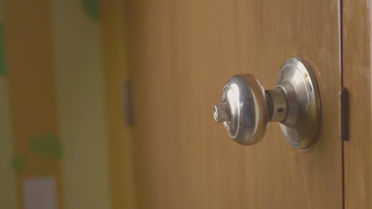 A hand turning a door knob | Premium Stock Video Footage