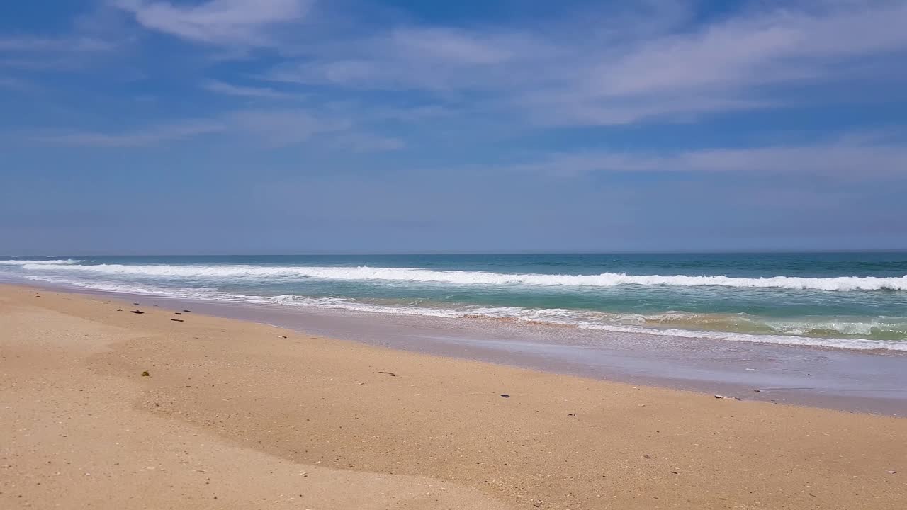 Premium stock video - Peace waves crash onto the beach in this wide ...