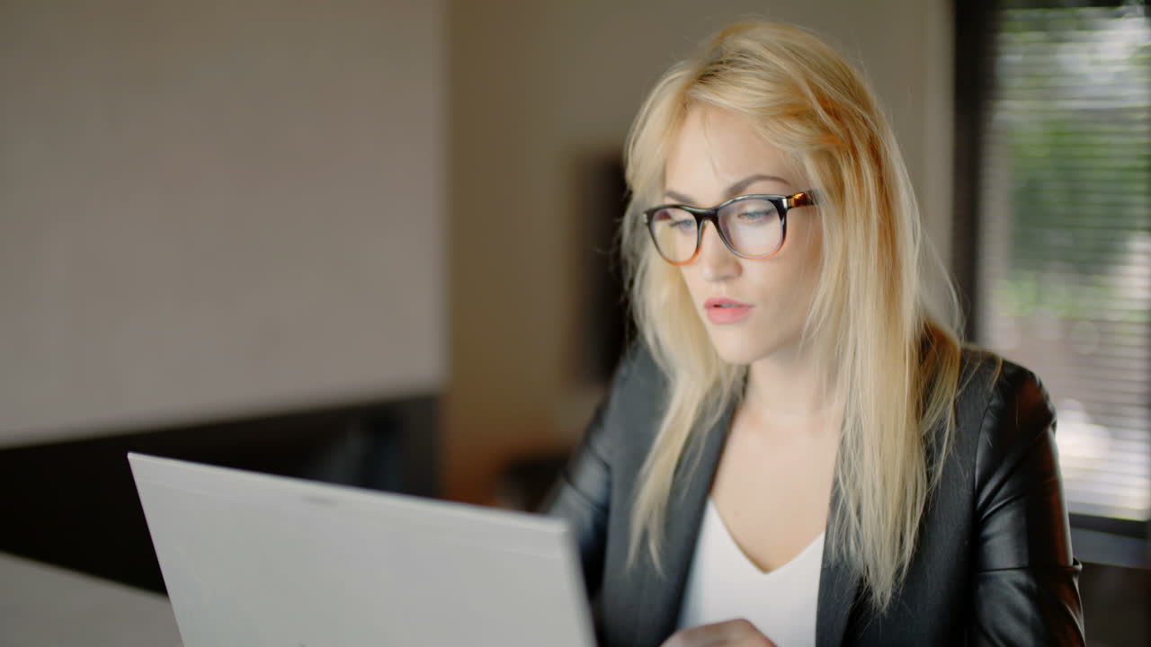 Premium stock video - Young woman working until late evening in office 1