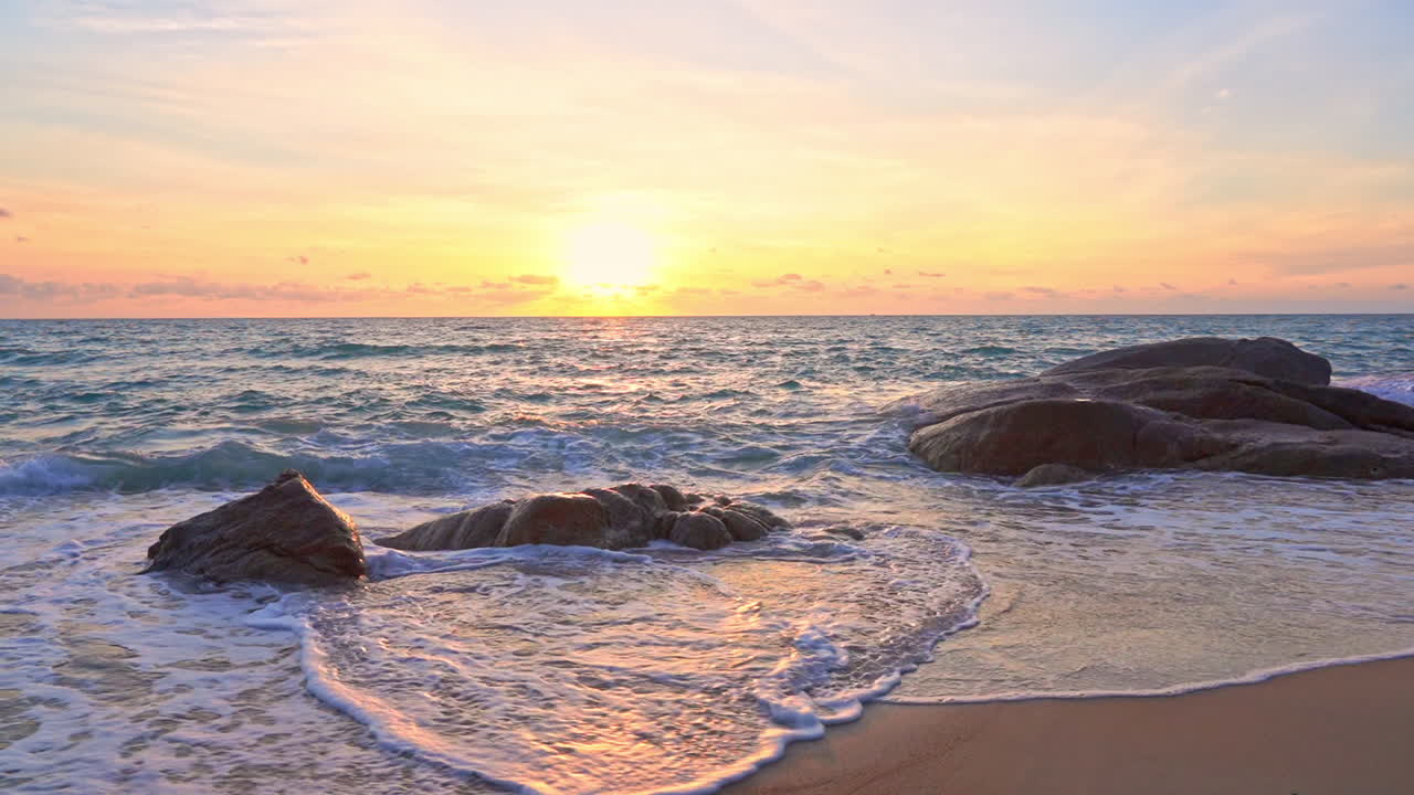 Foamy Sea Tides Rolling Over Stones On Sandy Beach At Sunset In ...