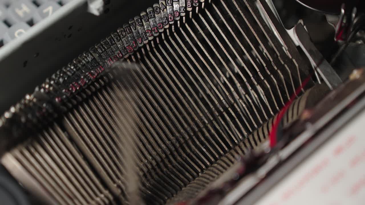 Hammers with the letters of the alphabet while typing on a typewriter ...