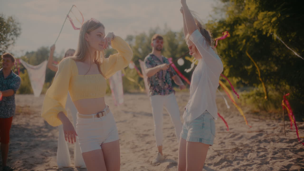 Premium stock video - Women dancing against friends grooving with ribbons