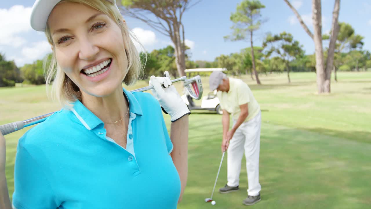 Premium stock video - Golfer carrying golf club over shoulder while ...