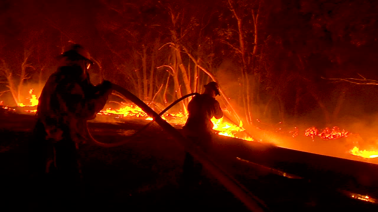 Premium stock video - Firefighters work hard to contain brush fires ...