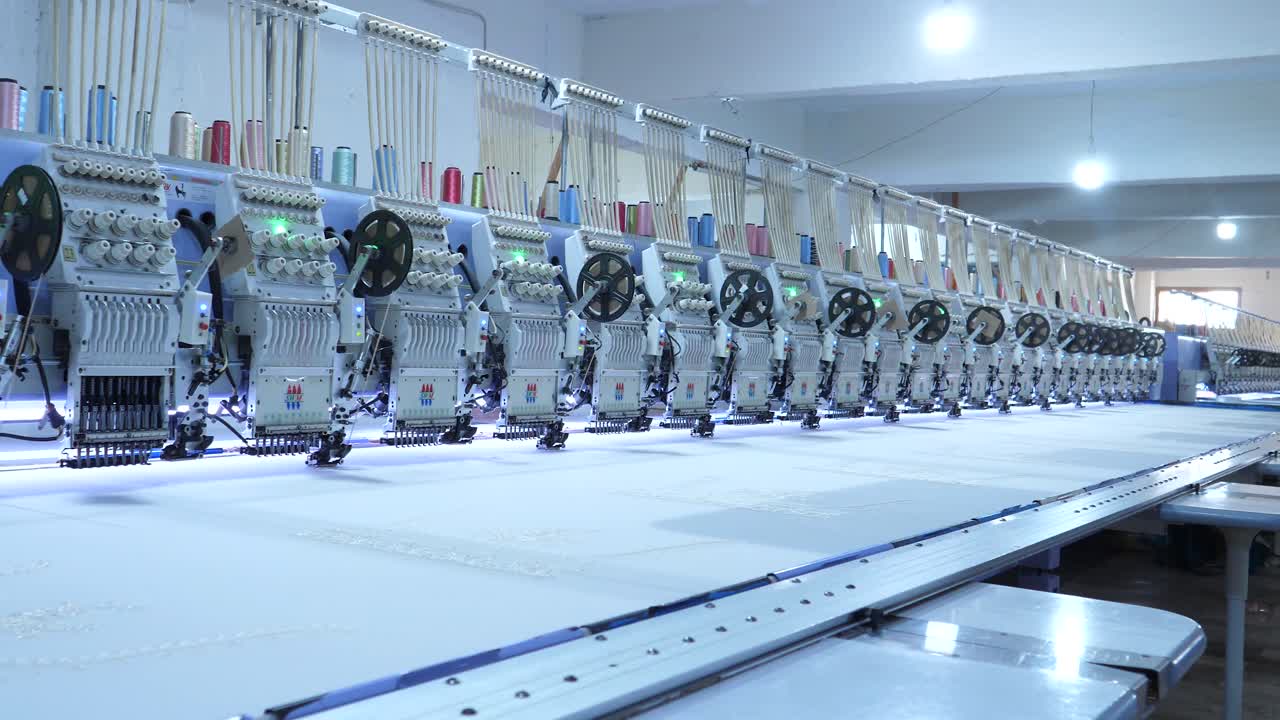 Premium stock video - View along row of automatic fabric embroidery ...