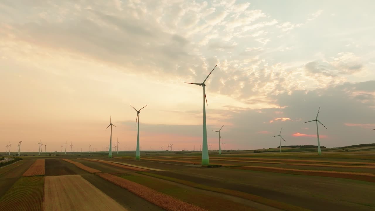 Premium stock video - Aerial view of wind turbines standing tall over ...