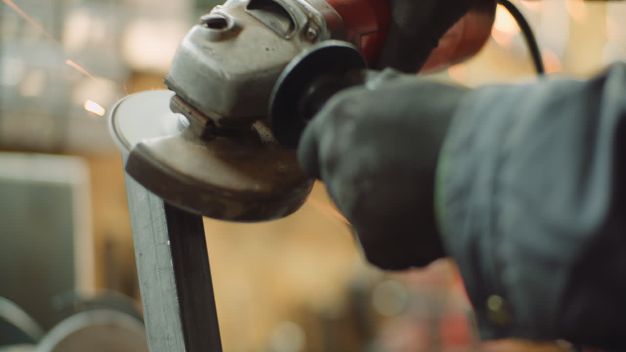 Free stock video - Angle grinder cutting metal at workshop
