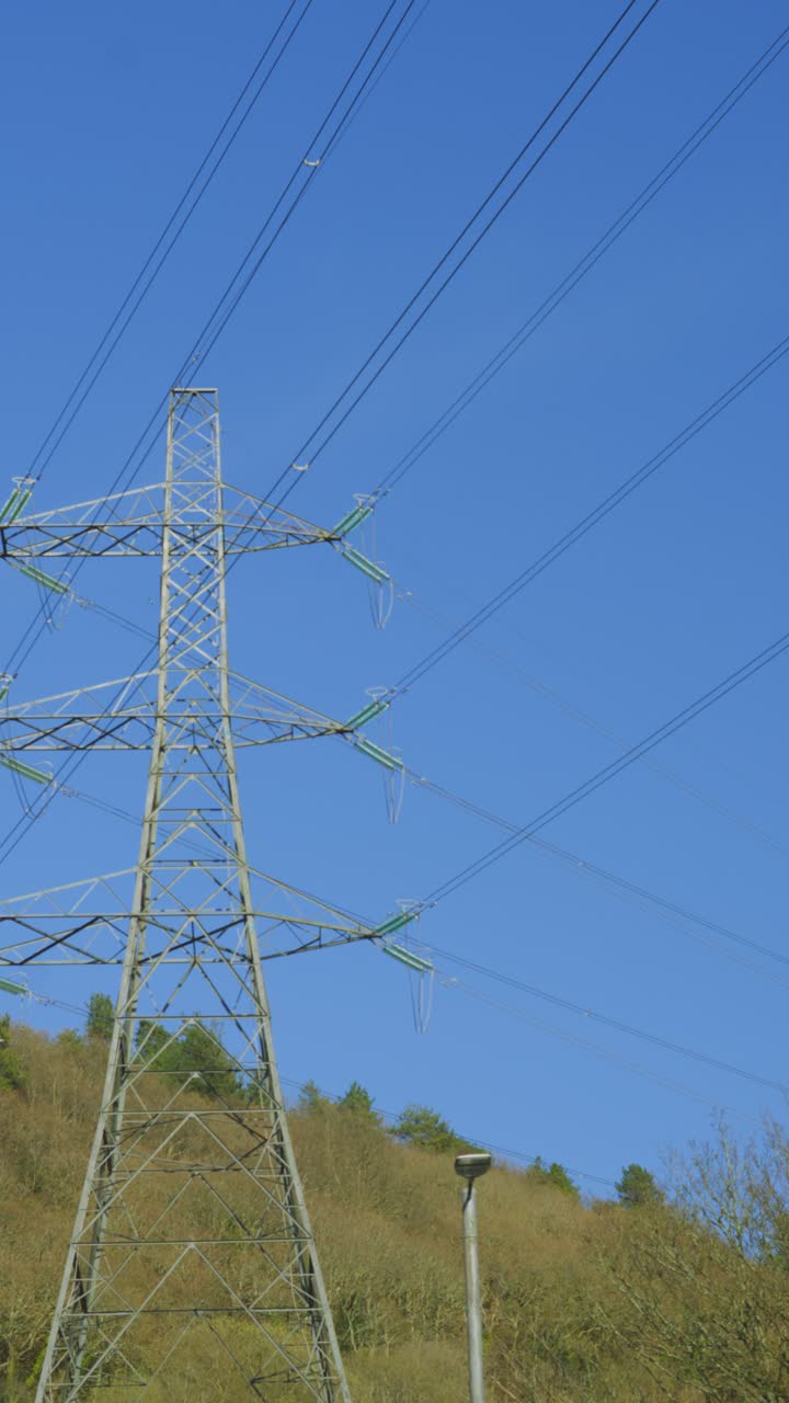 Vertical Video of Power Lines Running Through Metal Pylon Transporting ...