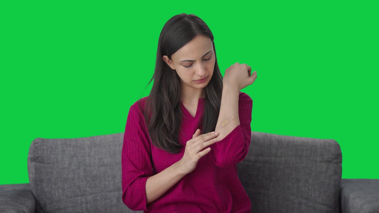 Indian woman applying a bandage Green screen | Premium Stock Video Footage