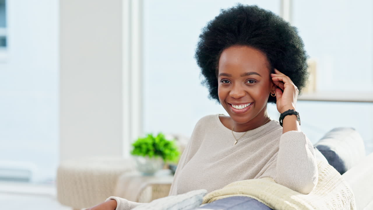 Premium stock video - Portrait of a happy afro woman relaxing on sofa