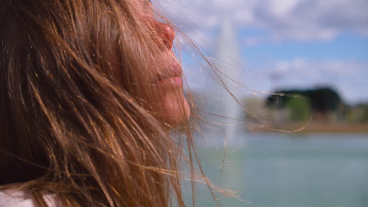 Premium stock video - Close up of young girl standing beside lake and ...