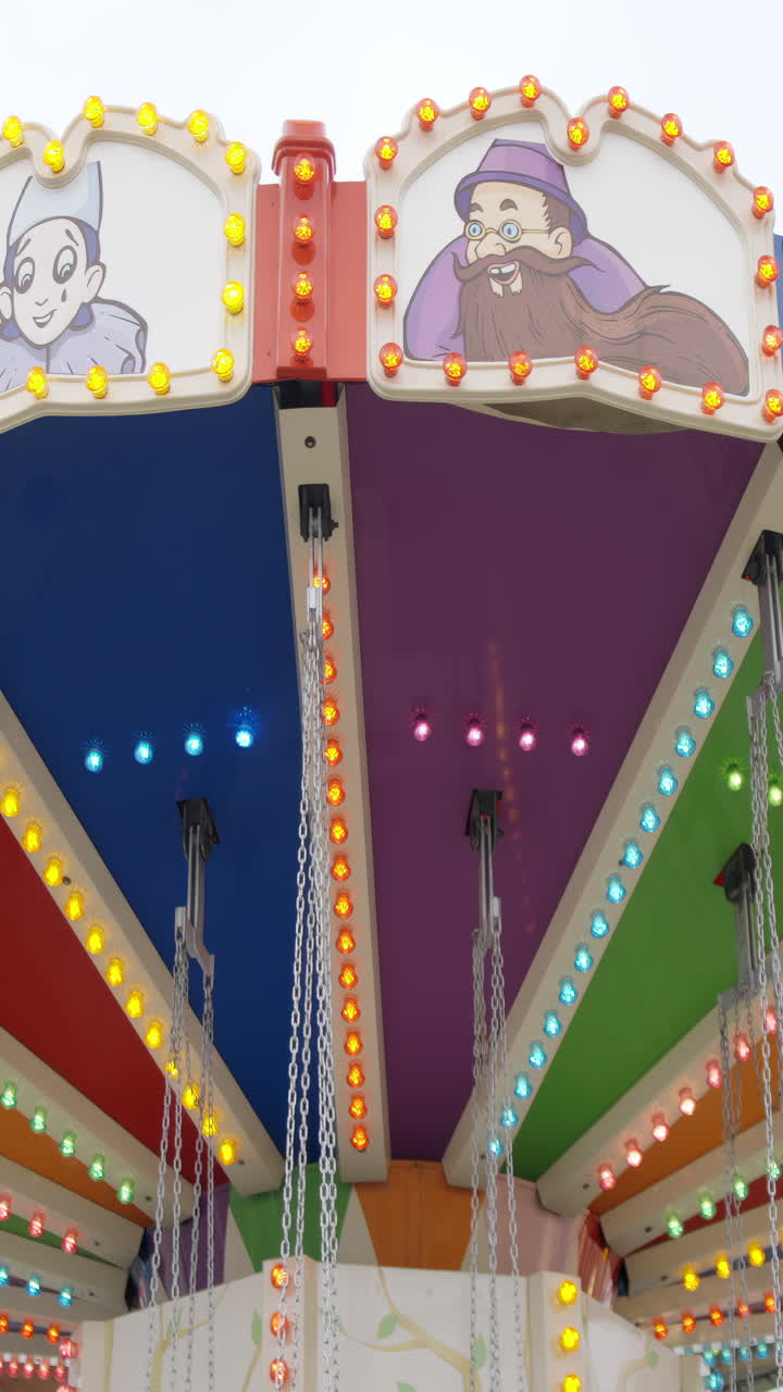 Colorful Lights and Cartoon Characters on an Amusement Park Ride ...