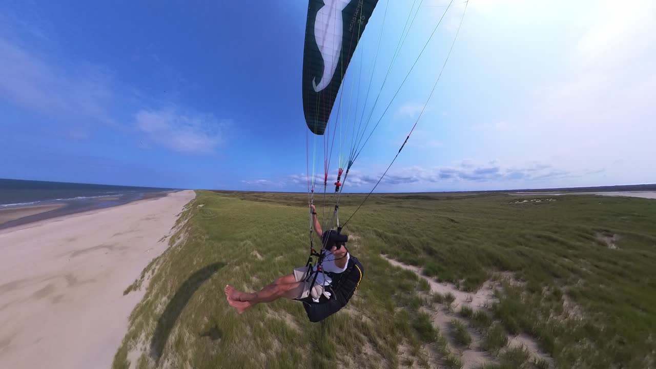 Premium stock video - Side fpv view of male paraglider speed soaring ...