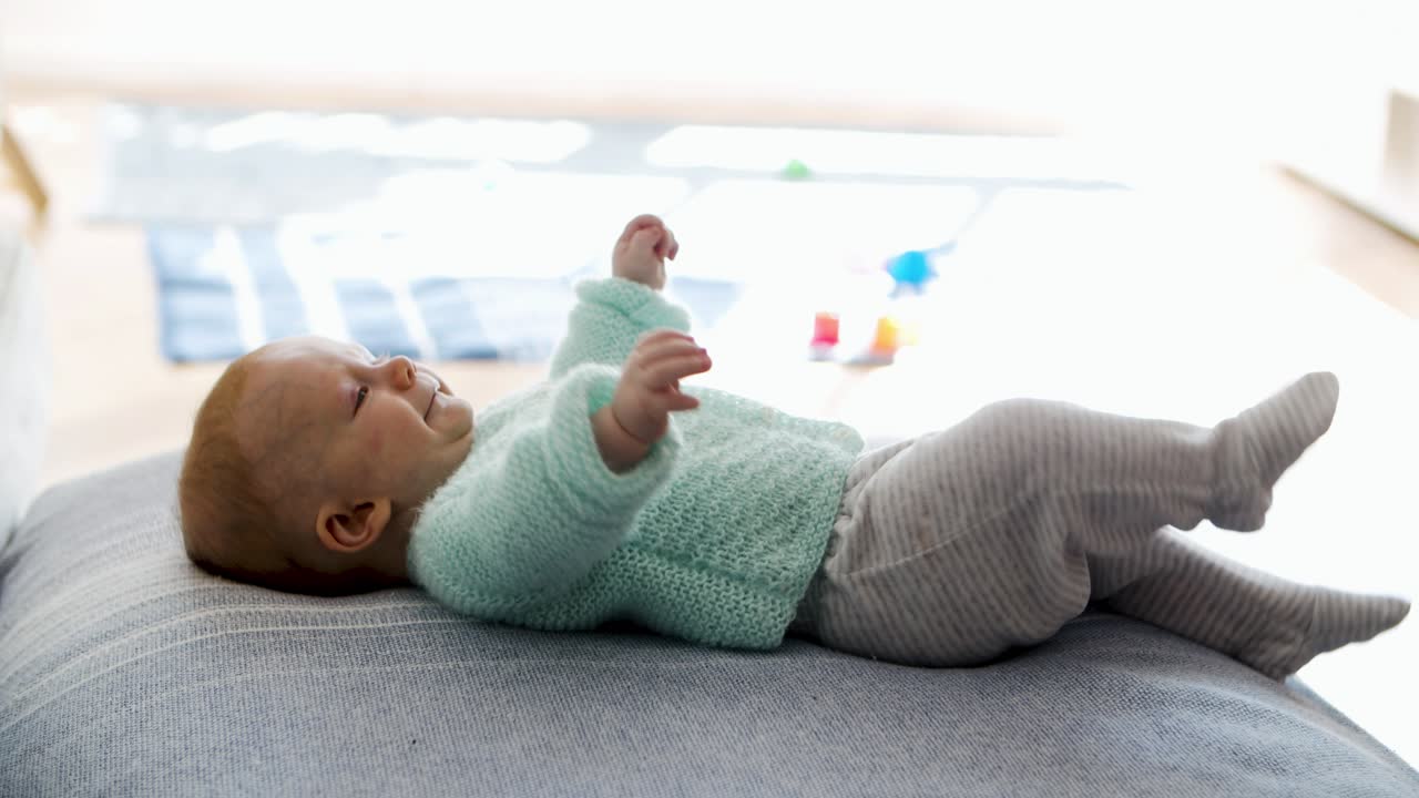 Side view of positive cute baby stirring hands and legs | Premium Stock ...